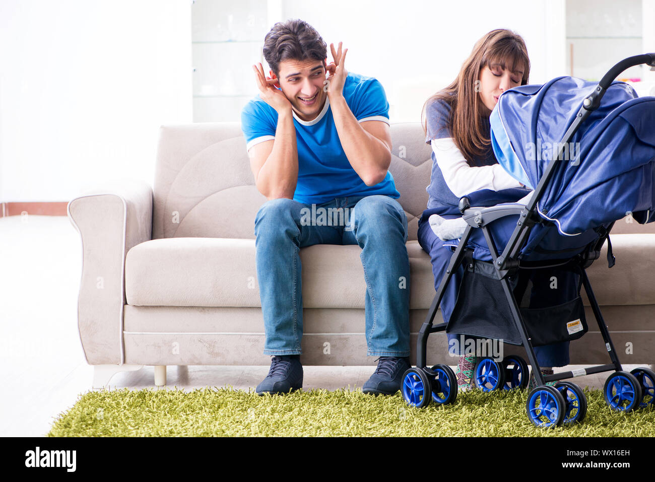 Young parents with their newborn baby in baby pram sitting on th Stock ...
