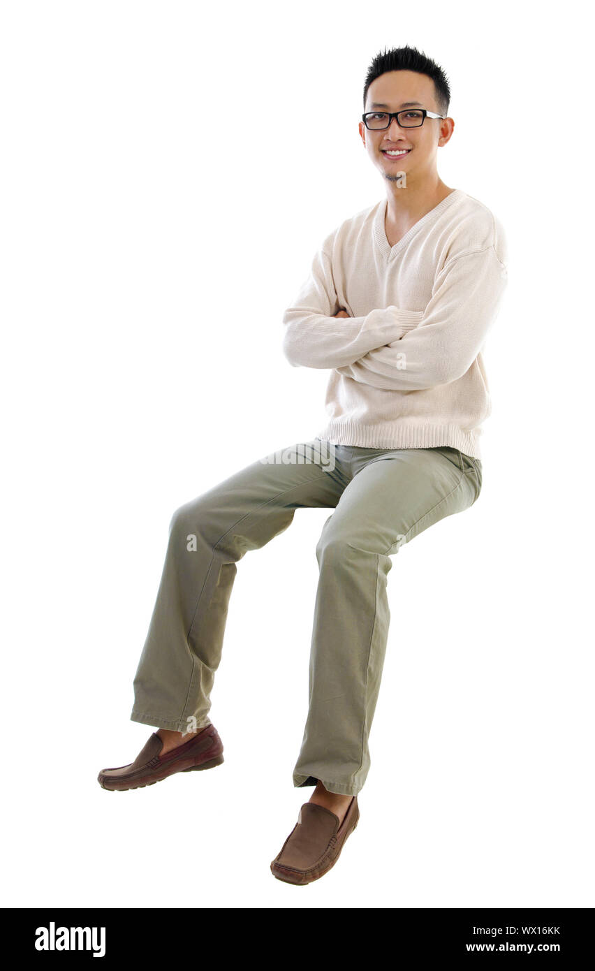 Full body Asian man sitting on a transparent block over white ...