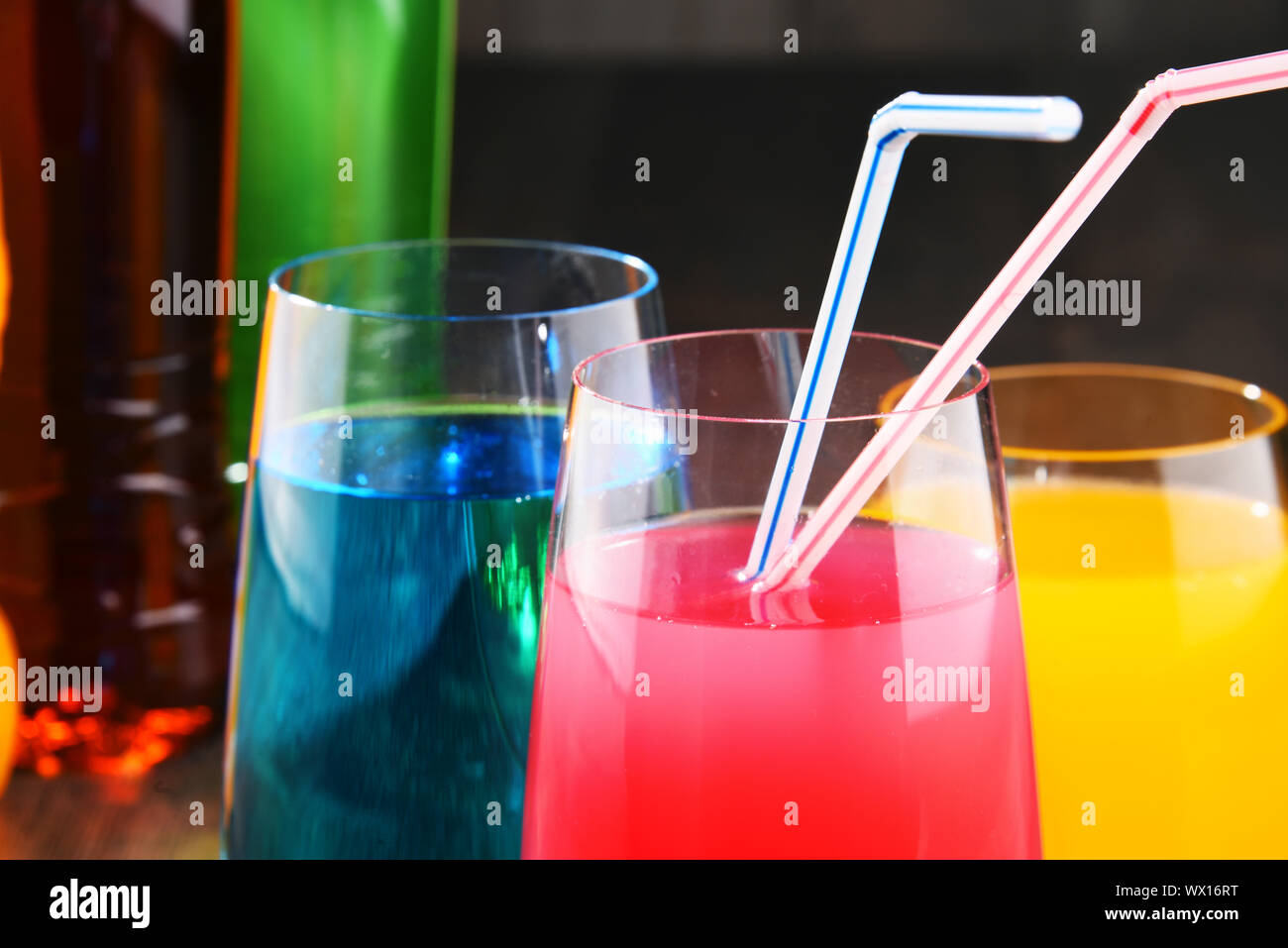 Glasses and bottles of assorted carbonated soft drinks in variety of ...