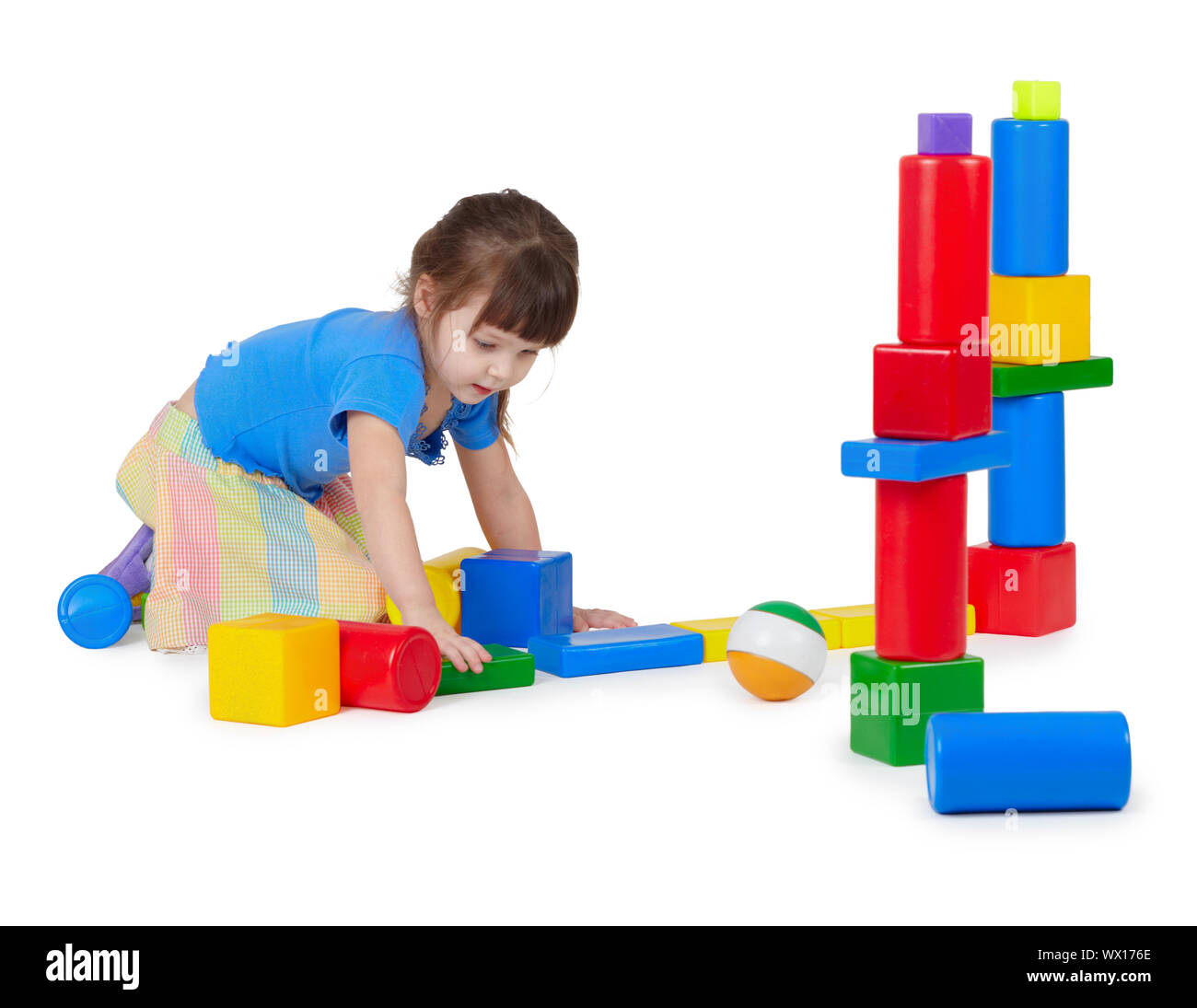 Girl playing toy bricks on white background Stock Photo - Alamy