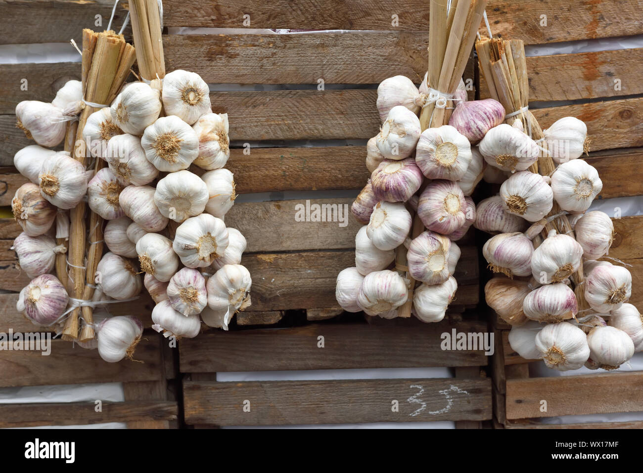 Garlic bunches on vintage wooden surface in the handicraft fair ...