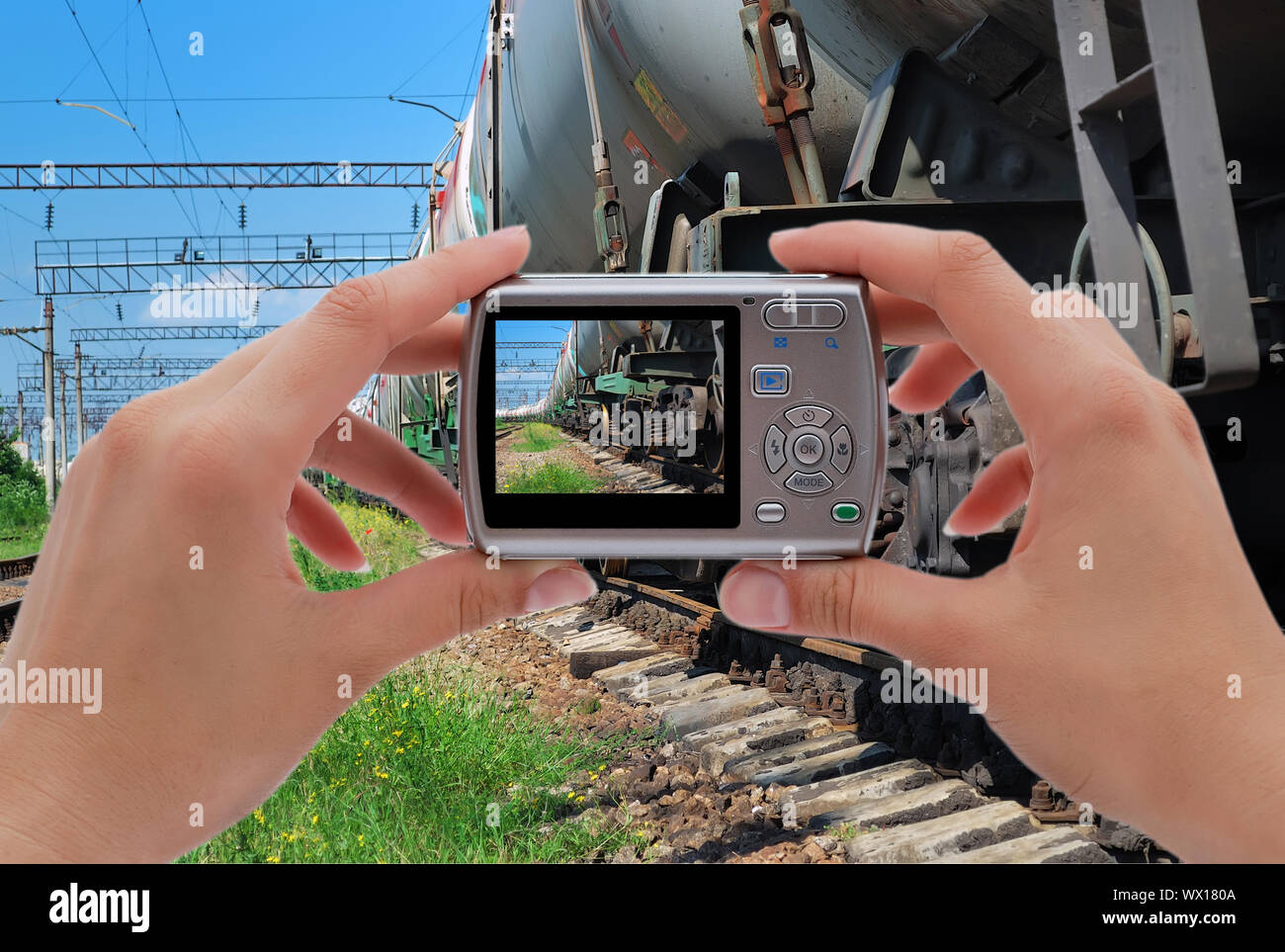 digital camera in hands of photographing tanks with oil Stock Photo - Alamy
