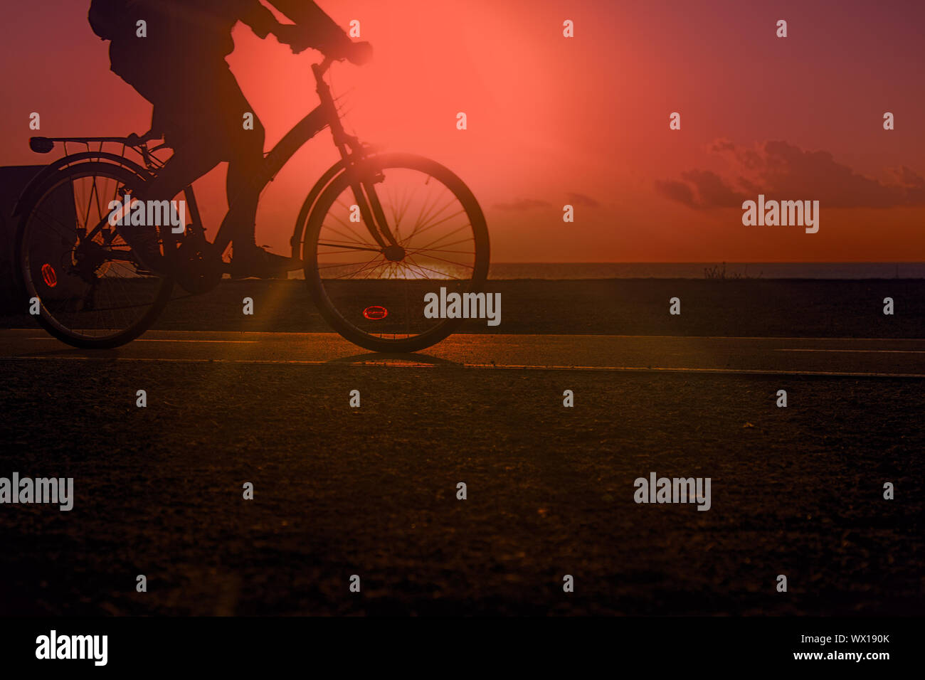 Bikes on beach, sunset sky background Stock Photo - Alamy