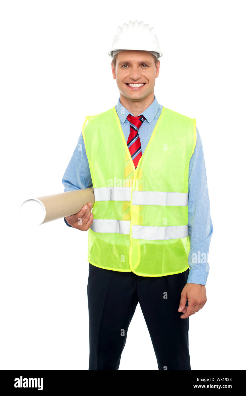 Happy male architect holding blueprints wearing helmet and safety ...