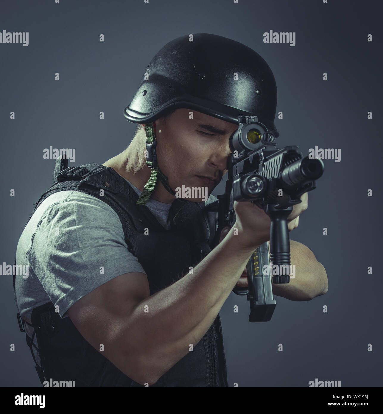 Security, paintball sport player wearing protective helmet aiming ...