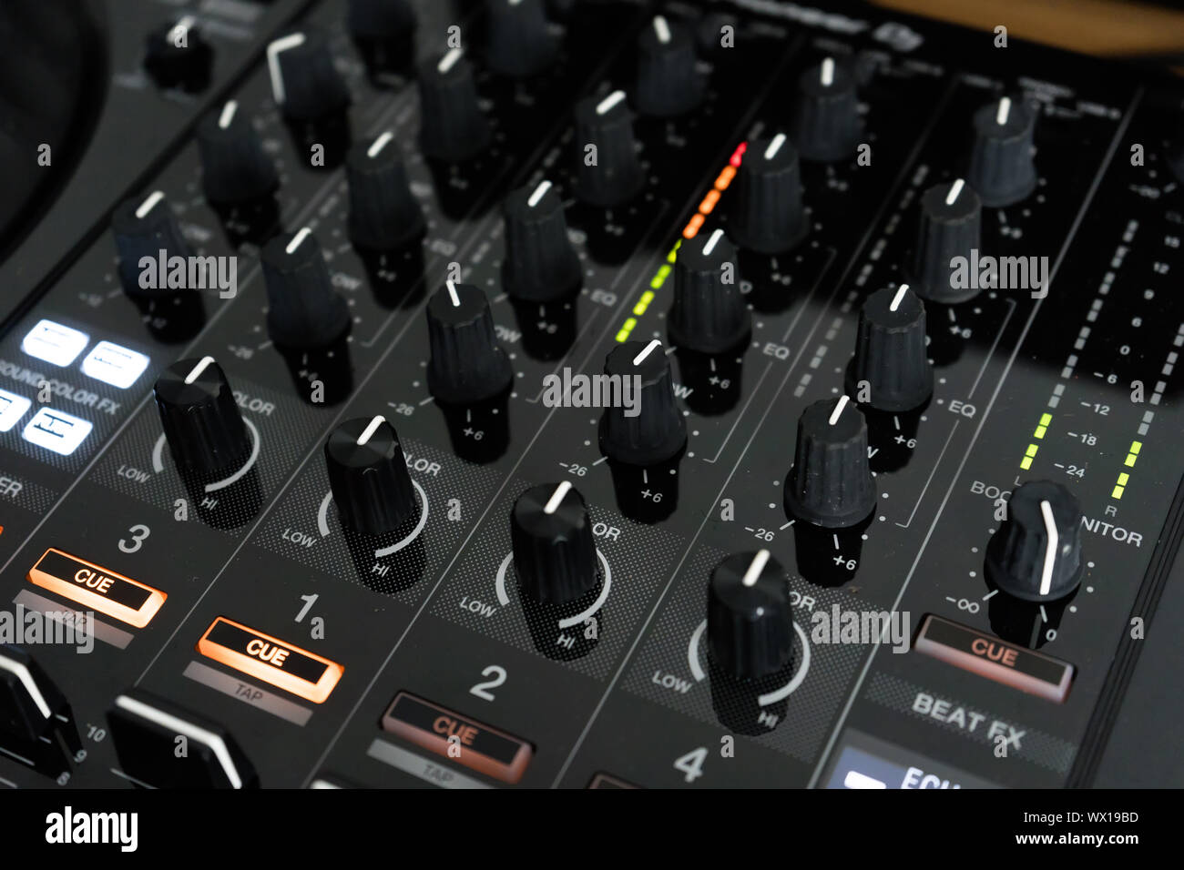 Wide angle photo of black sound mixer controller with knobs and sliders ...
