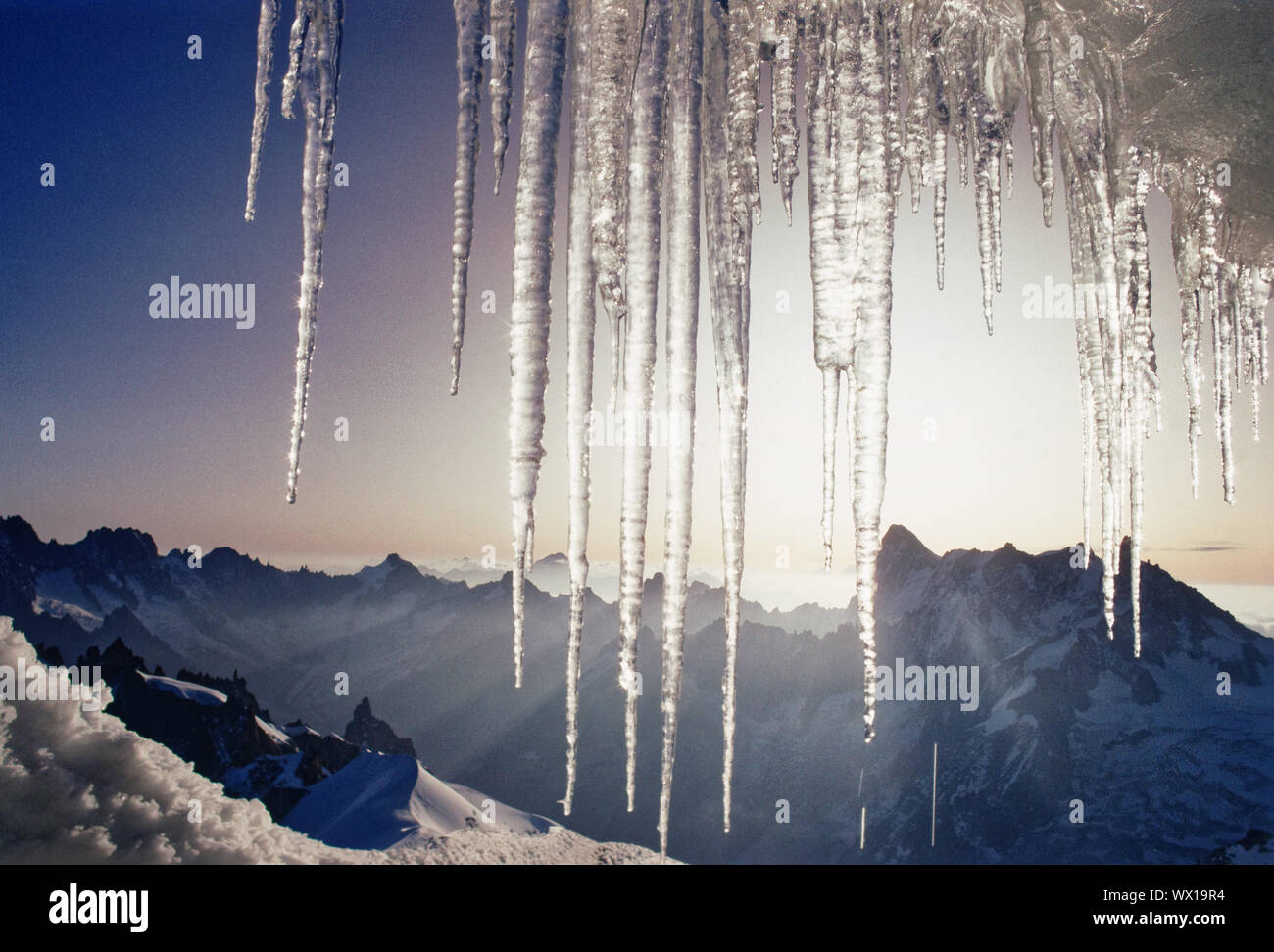 The sun rising behind icicles in the French Alps Stock Photo - Alamy