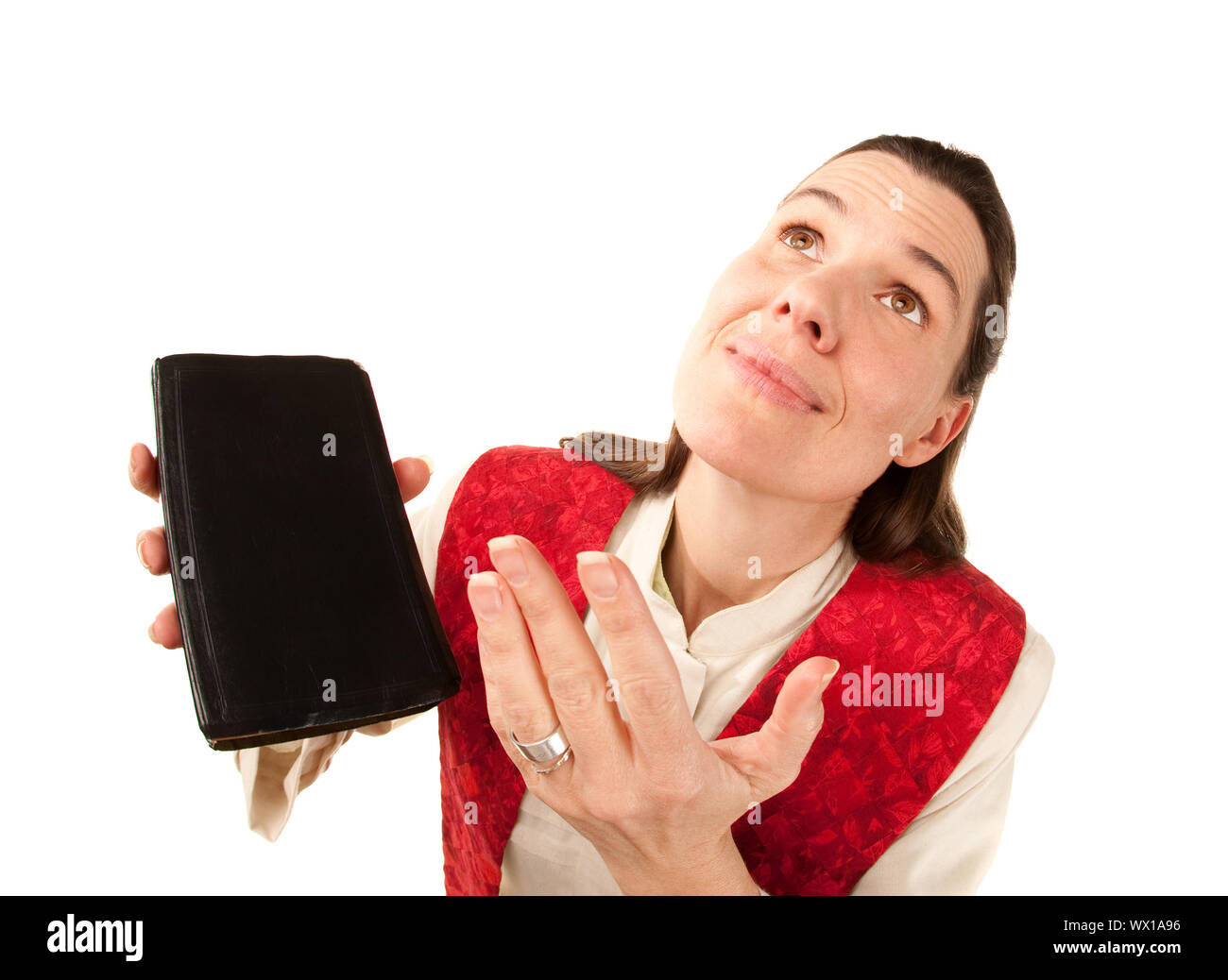 Female pastor with Bible making big prayer gesture to God or heaven ...