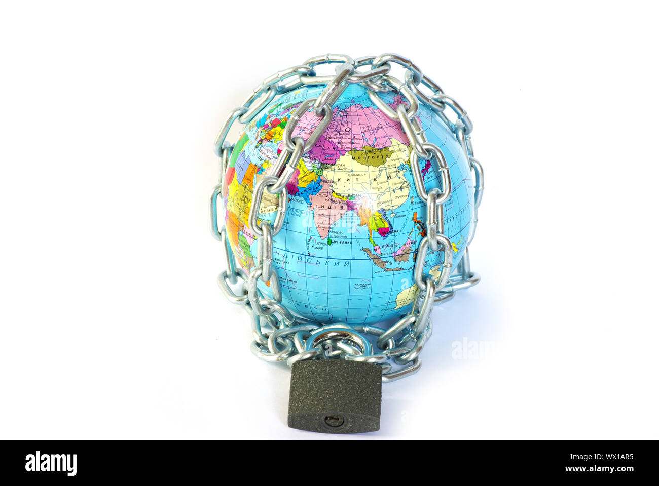 Lock and chain on the globe of the world Stock Photo - Alamy
