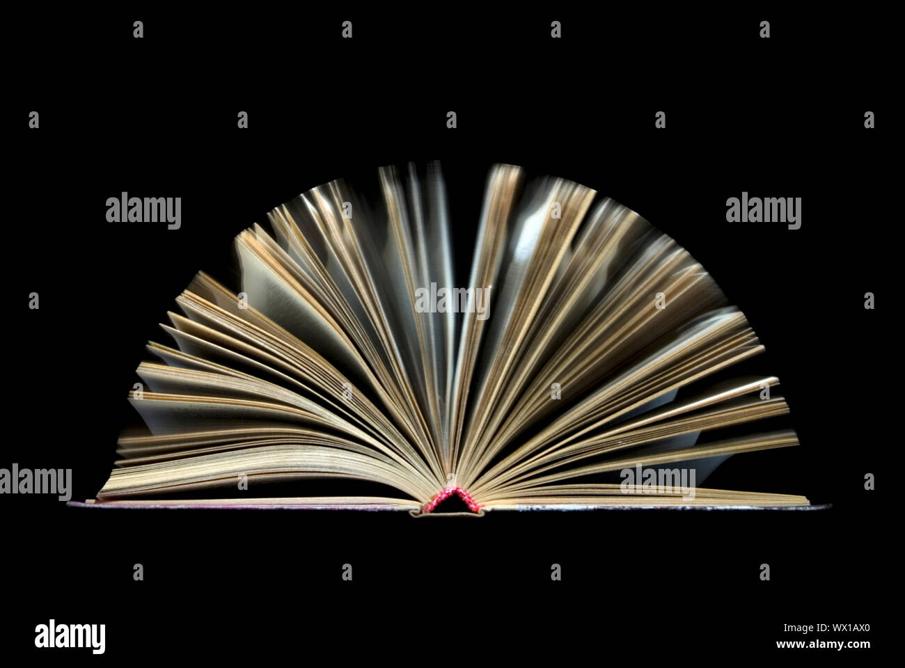 open book on black background Stock Photo - Alamy