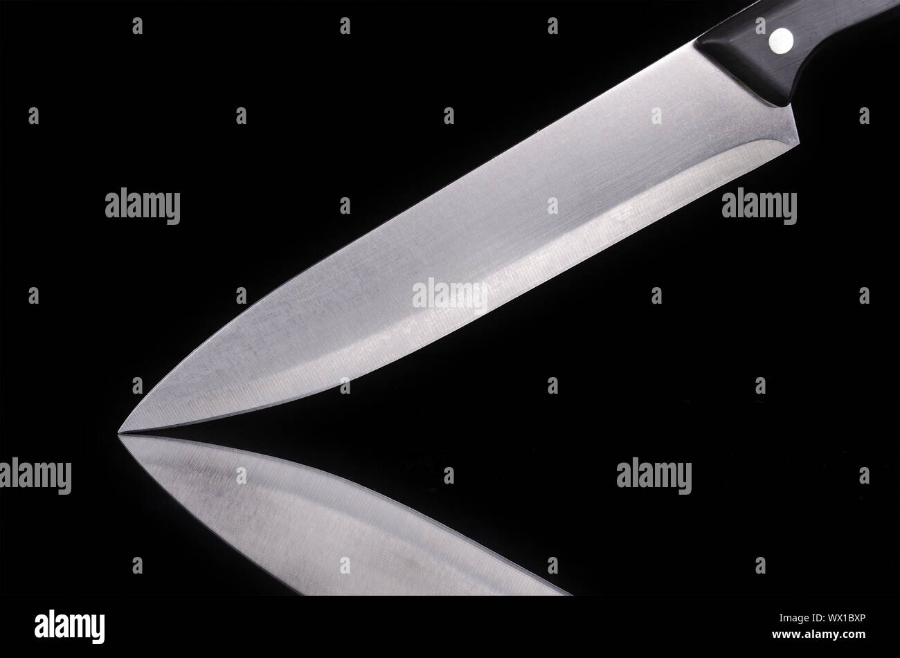 Close up view of a kitchen knife over black isolated background Stock ...