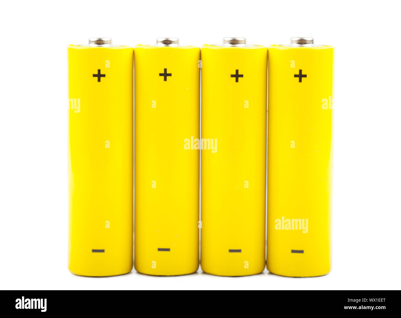 Four yellow batteries isolated over white background Stock Photo - Alamy