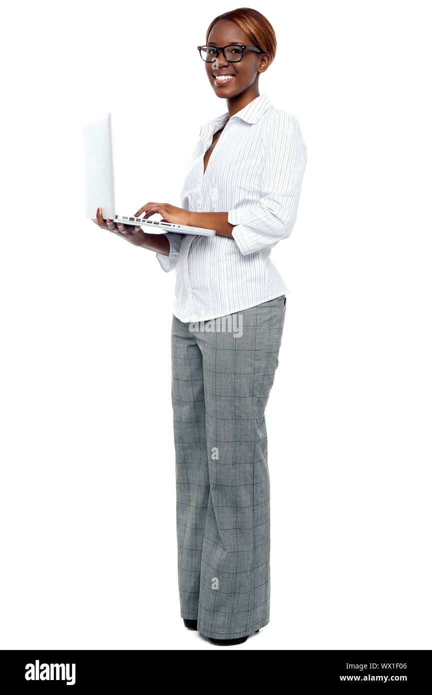 African businesswoman working on laptop. Full length portrait Stock ...