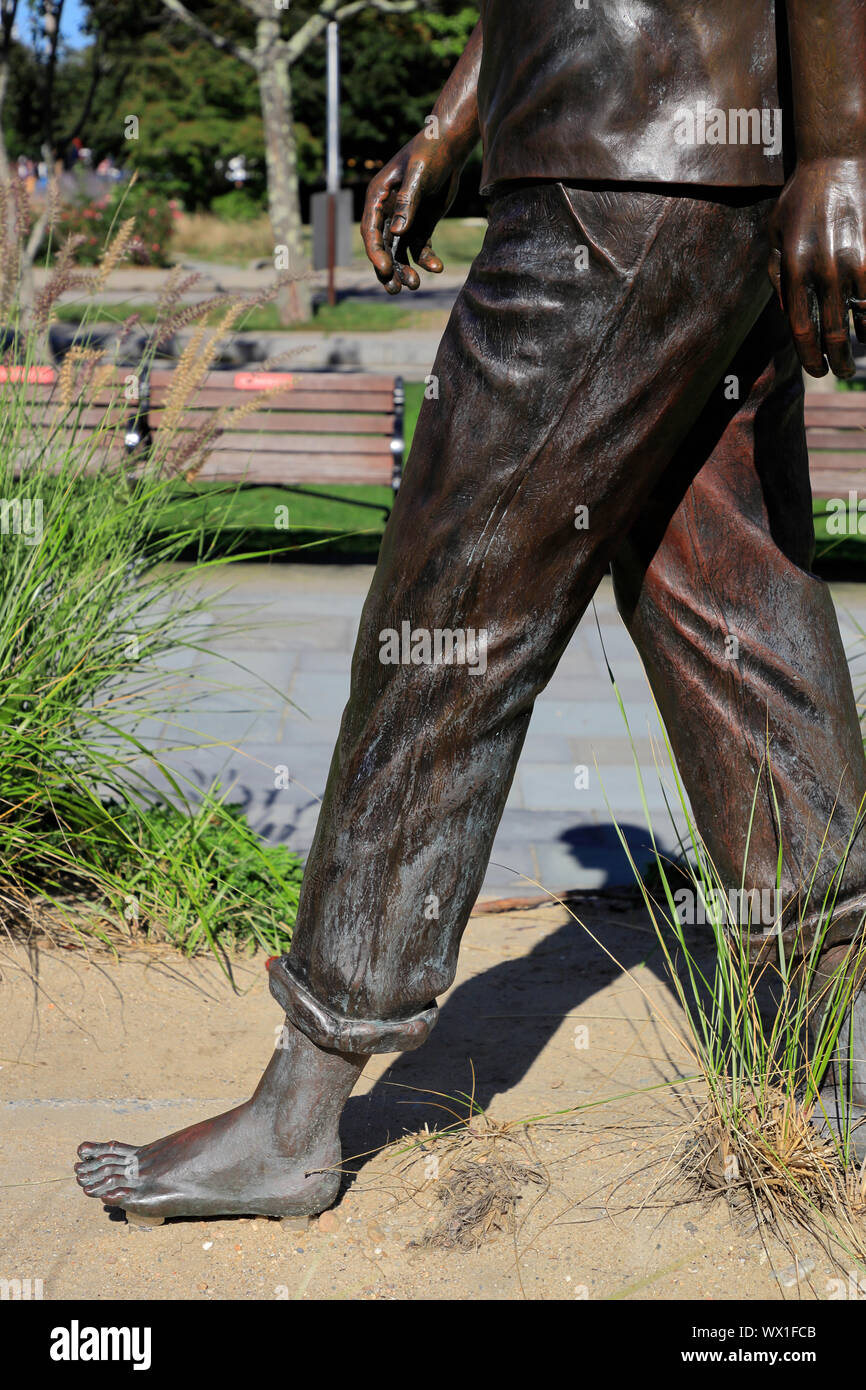 A closed up detailed view of bronze statue of John F. Kennedy in front ...