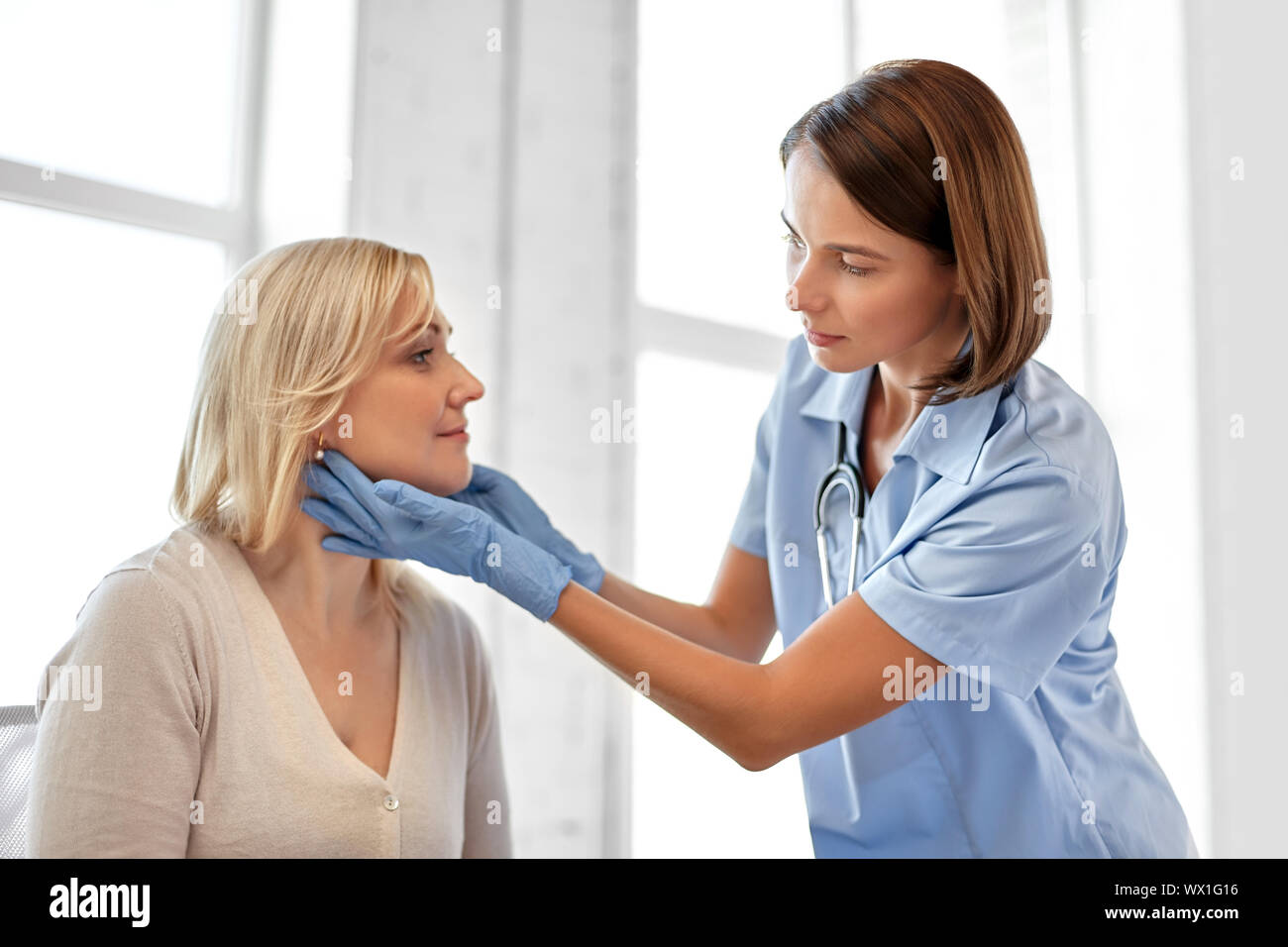 doctor checking patient's tonsils at hospital Stock Photo - Alamy