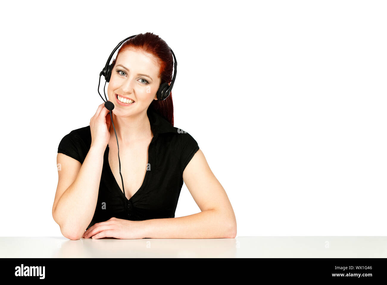 Professional woman talking on a headset in her office at work. With ...