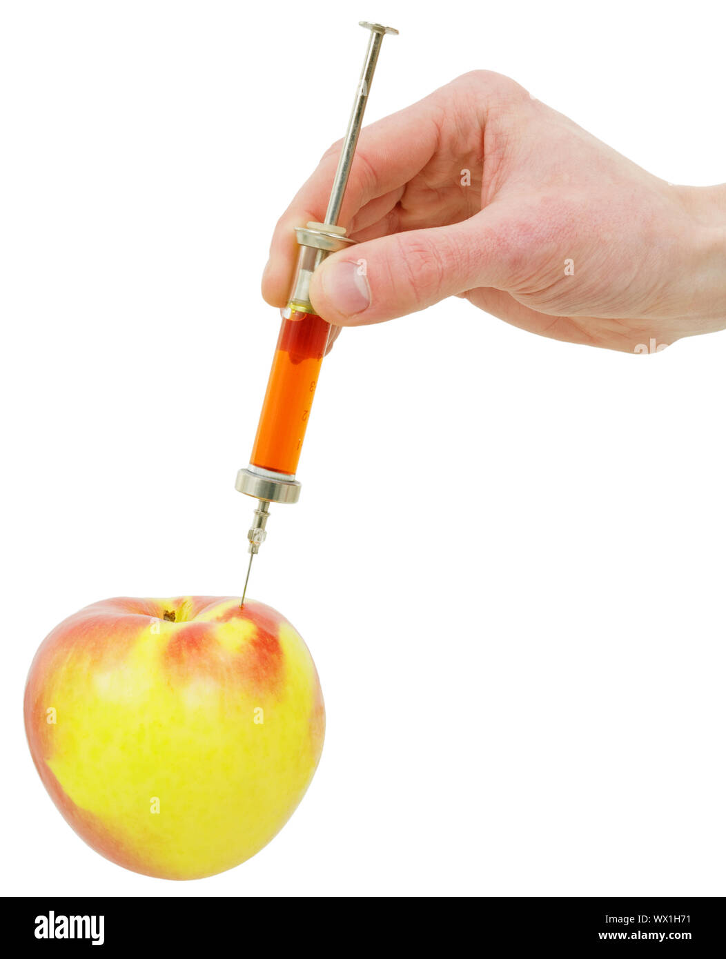 Hand with a syringe doing an injection to an apple on the white ...