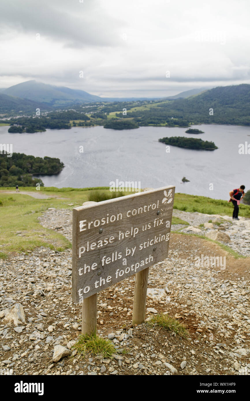 A sign asking people to walk on the path and stop erosion in the Lake ...