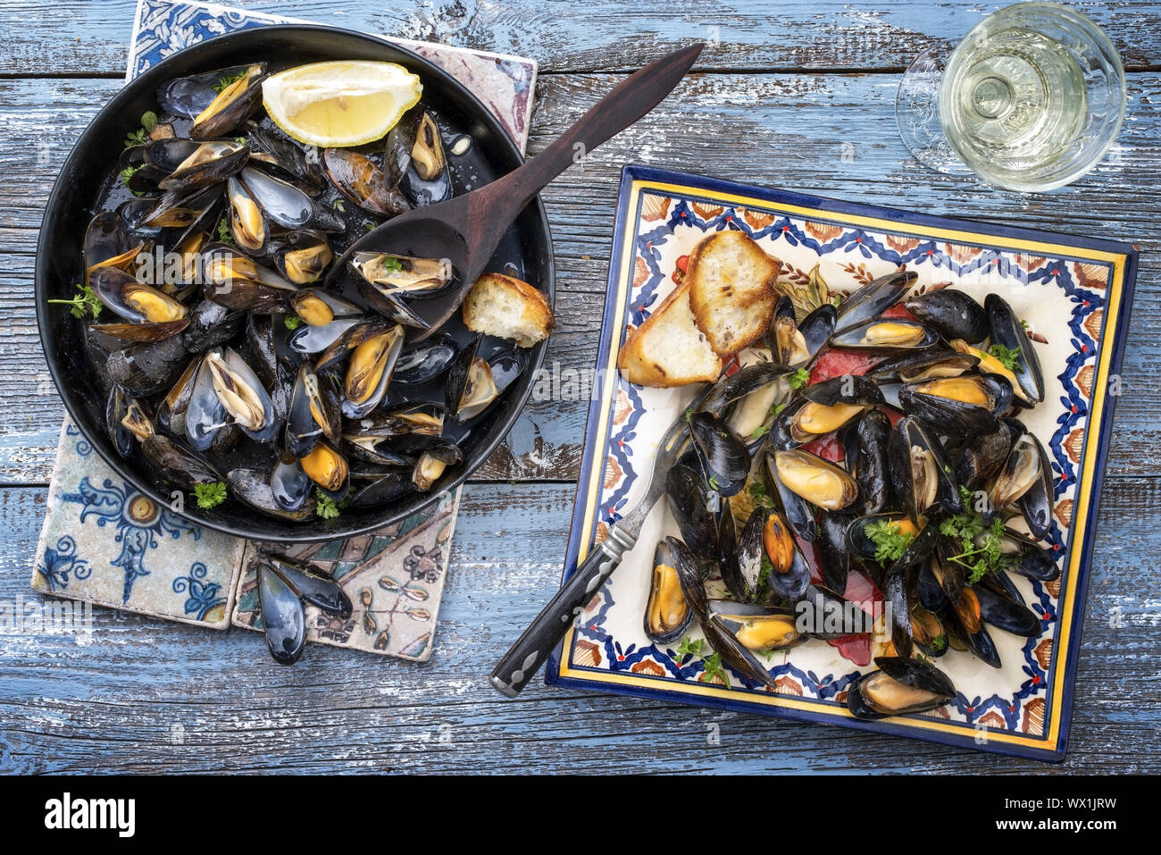 Traditional barbecue Italian blue mussel in white wine as top view on a ...