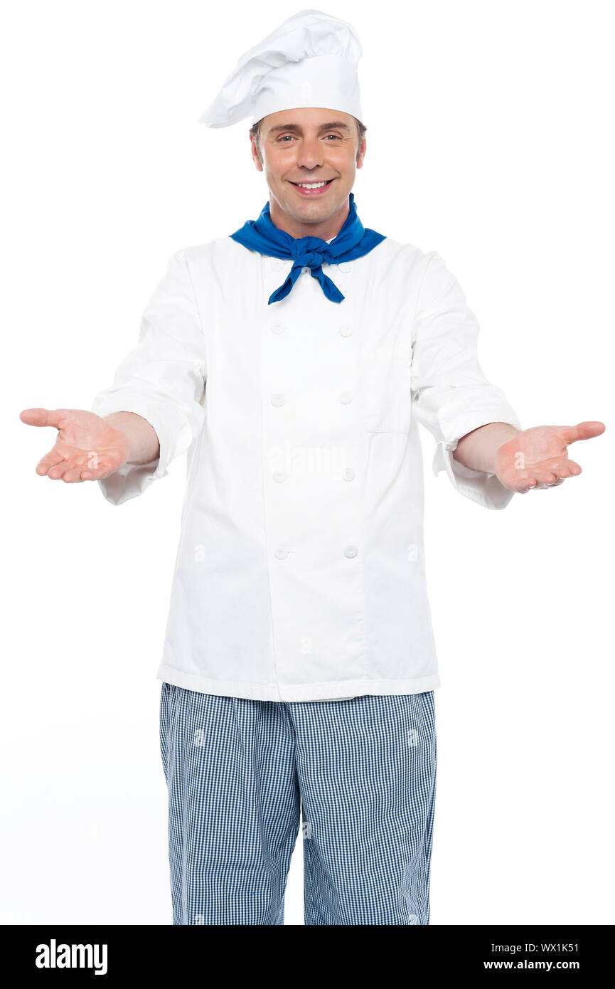Smiling chef posing with his arms wide open, welcoming guests Stock ...