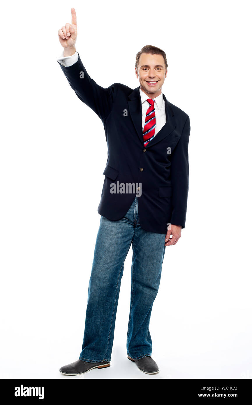 Tall and smart business representative posing with his finger raised ...