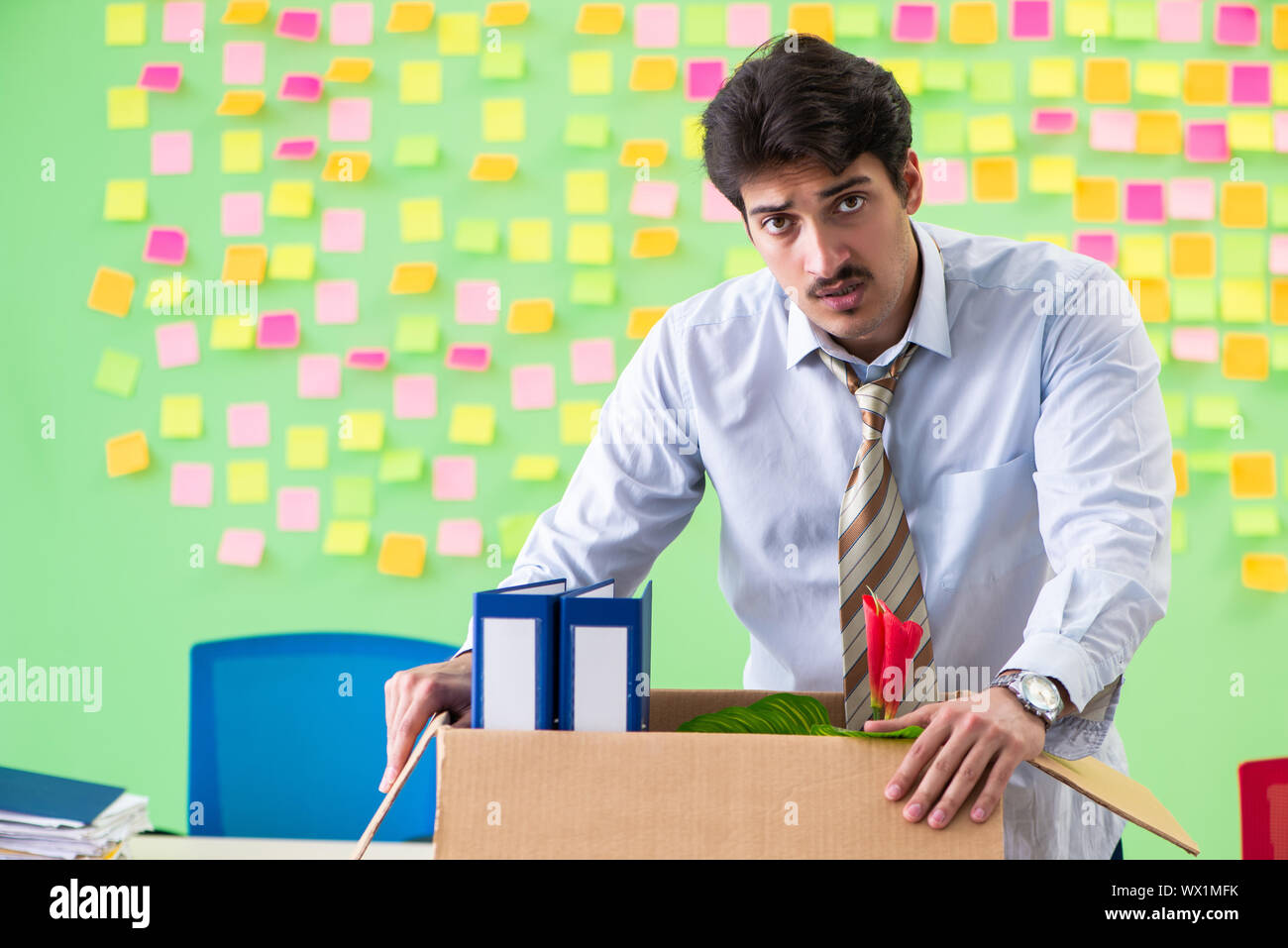 Man collecting his stuff after redundancy in the office with man Stock ...