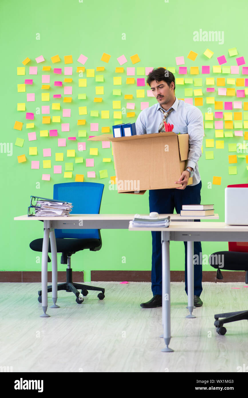 Man collecting his stuff after redundancy in the office with man Stock ...