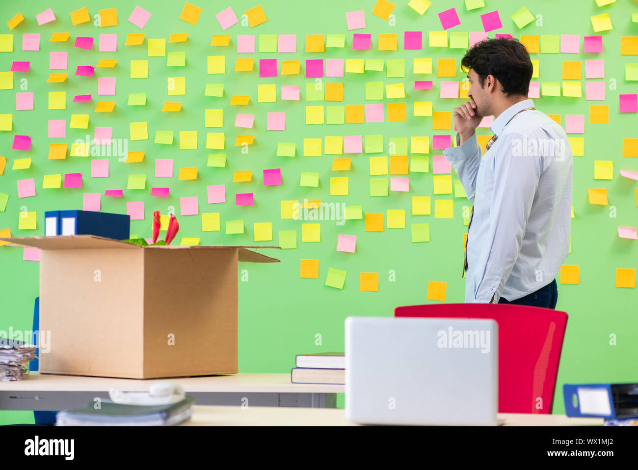 Man collecting his stuff after redundancy in the office with man Stock ...