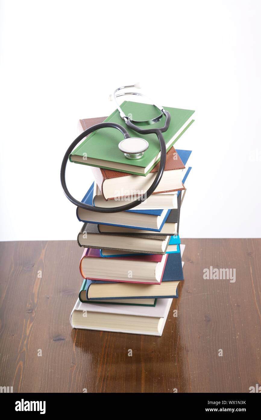 group of books piled on table and white background Stock Photo - Alamy