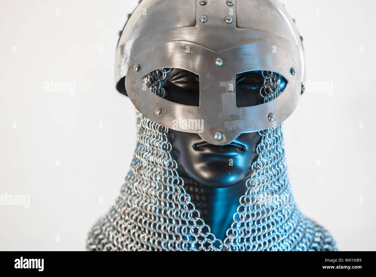 Viking helmet with chain mail in a black mannequin on white background ...