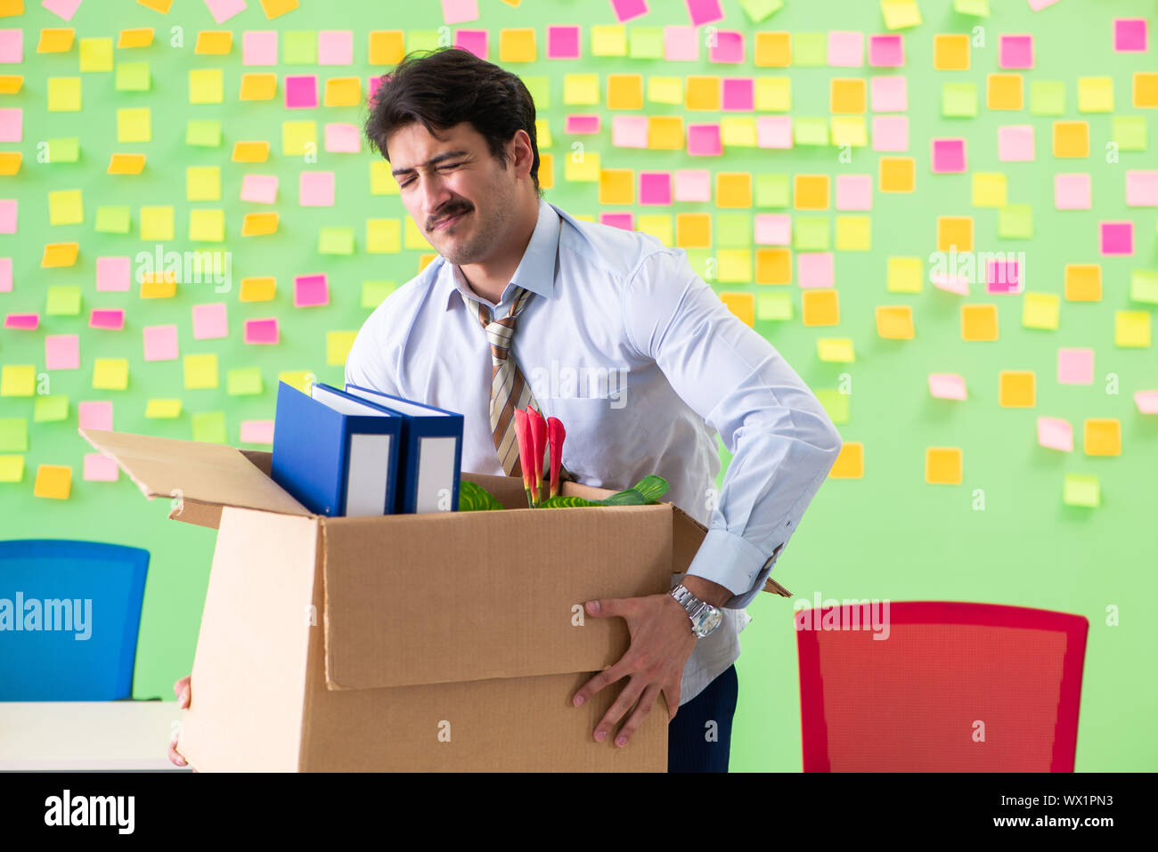 Man collecting his stuff after redundancy in the office with man Stock ...