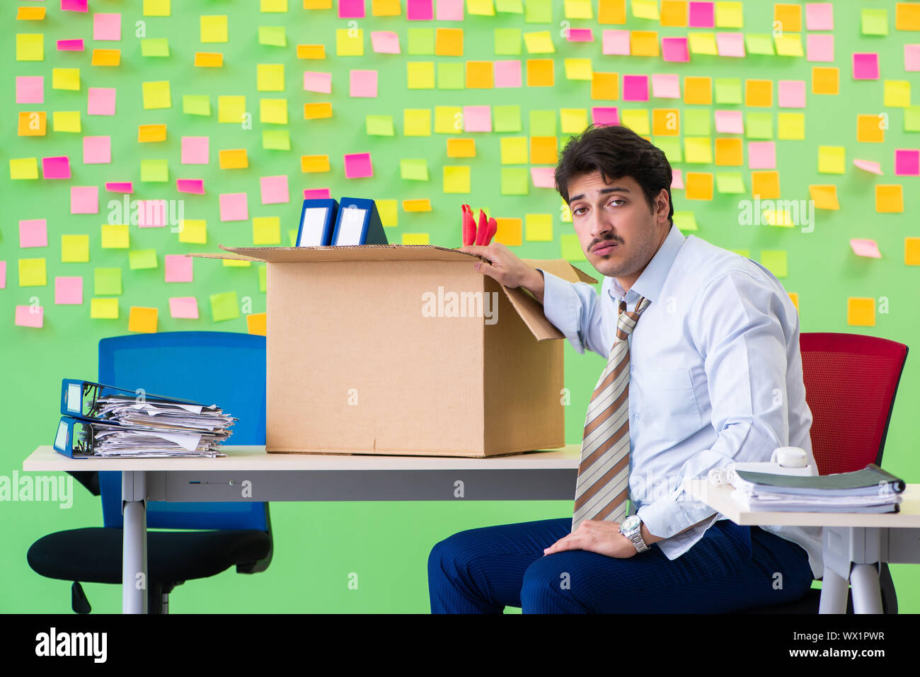 Man collecting his stuff after redundancy in the office with man Stock ...