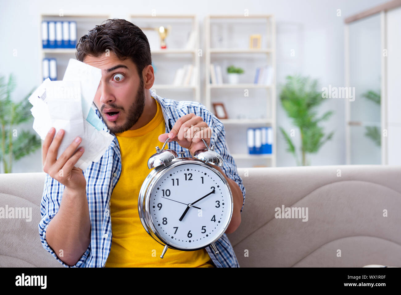 Man frustrated at bills he needs to pay in time management conce Stock ...