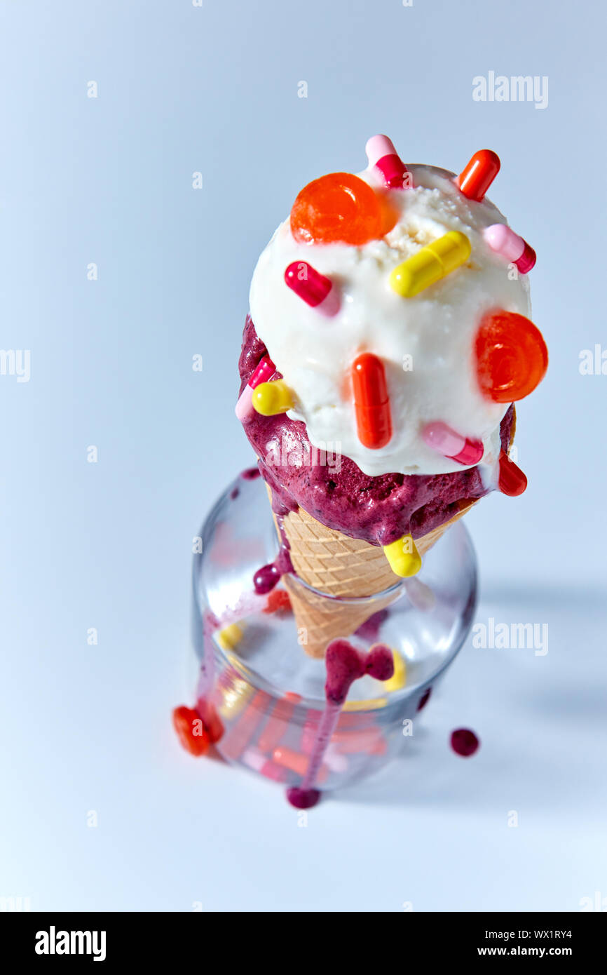 Appetizing ice cream balls in a waffle glass with tablets capsules in a ...