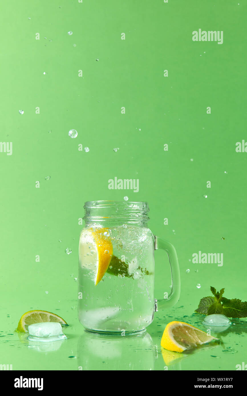 Splash lemonade in different directions from a mason jar with natural ...