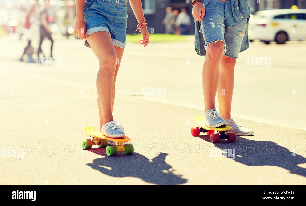 teenage couple riding skateboards on city street Stock Photo - Alamy