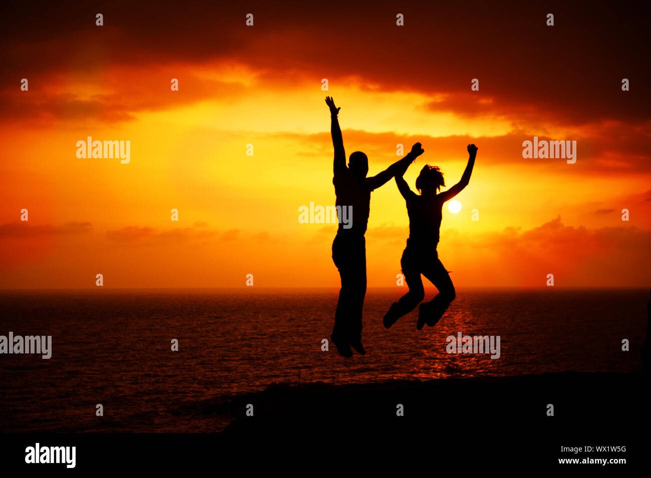 Two Happy Jumping People Stock Photo - Alamy