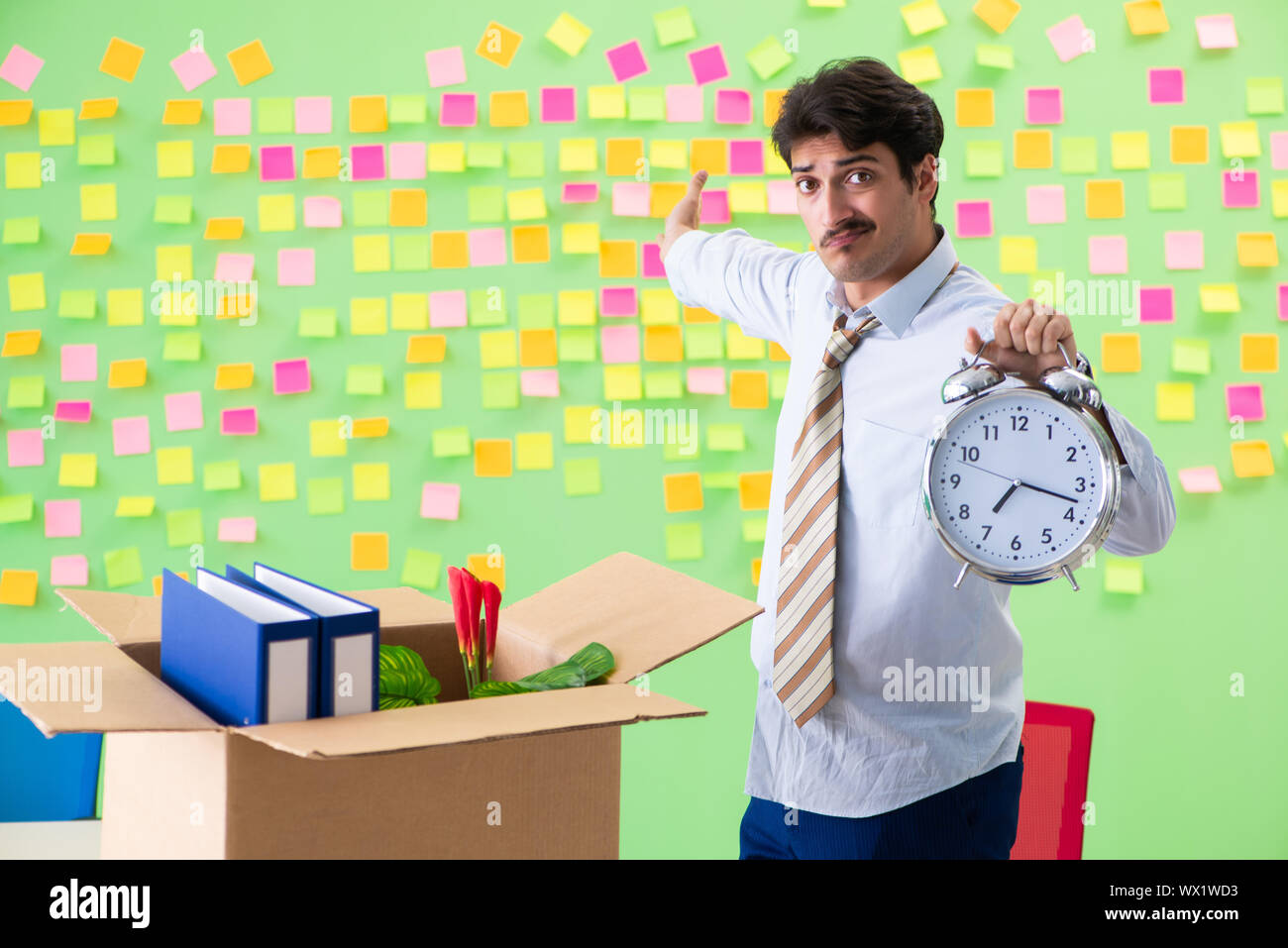 Man collecting his stuff after redundancy in the office with man Stock ...