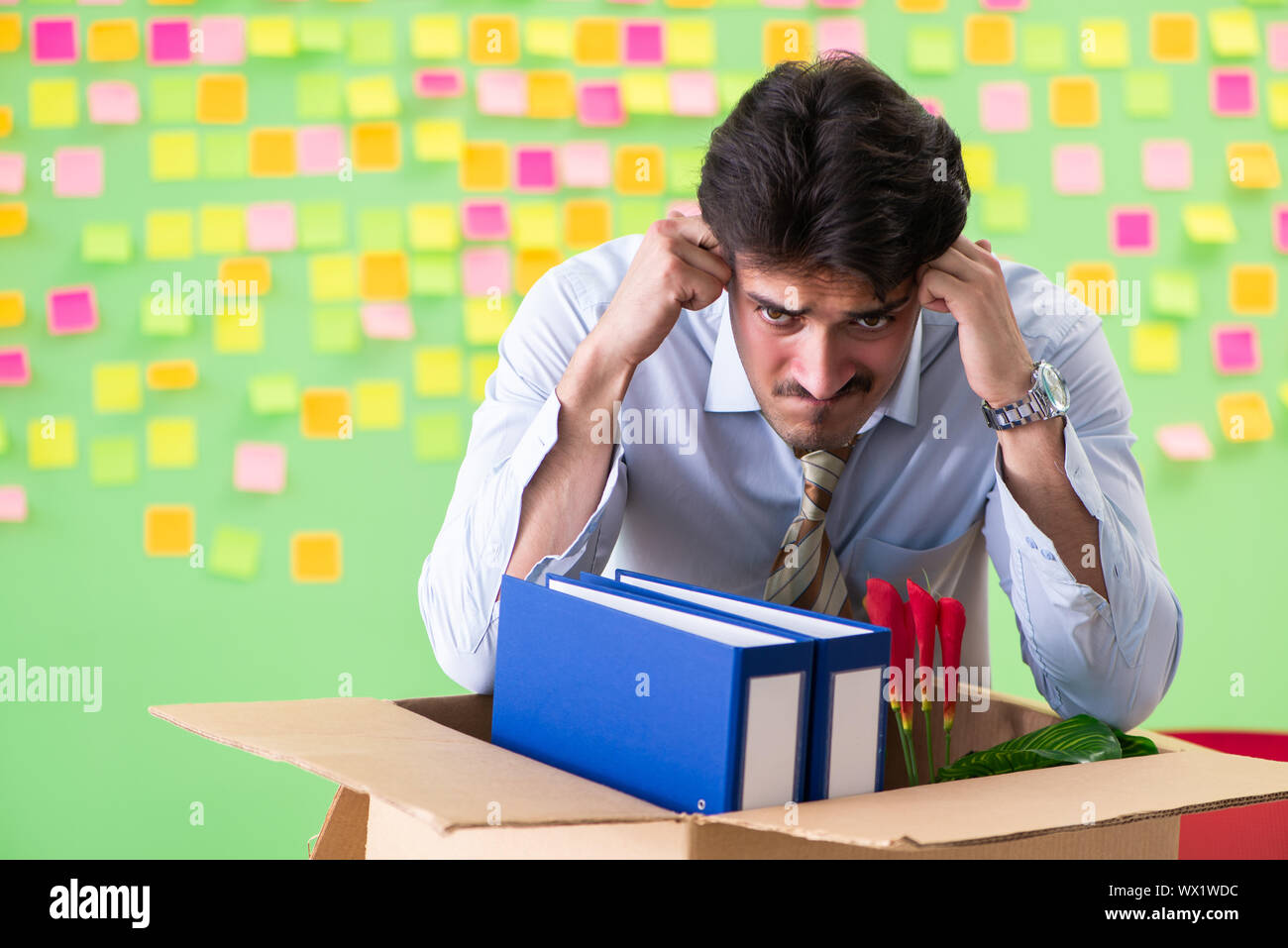 Man collecting his stuff after redundancy in the office with man Stock ...