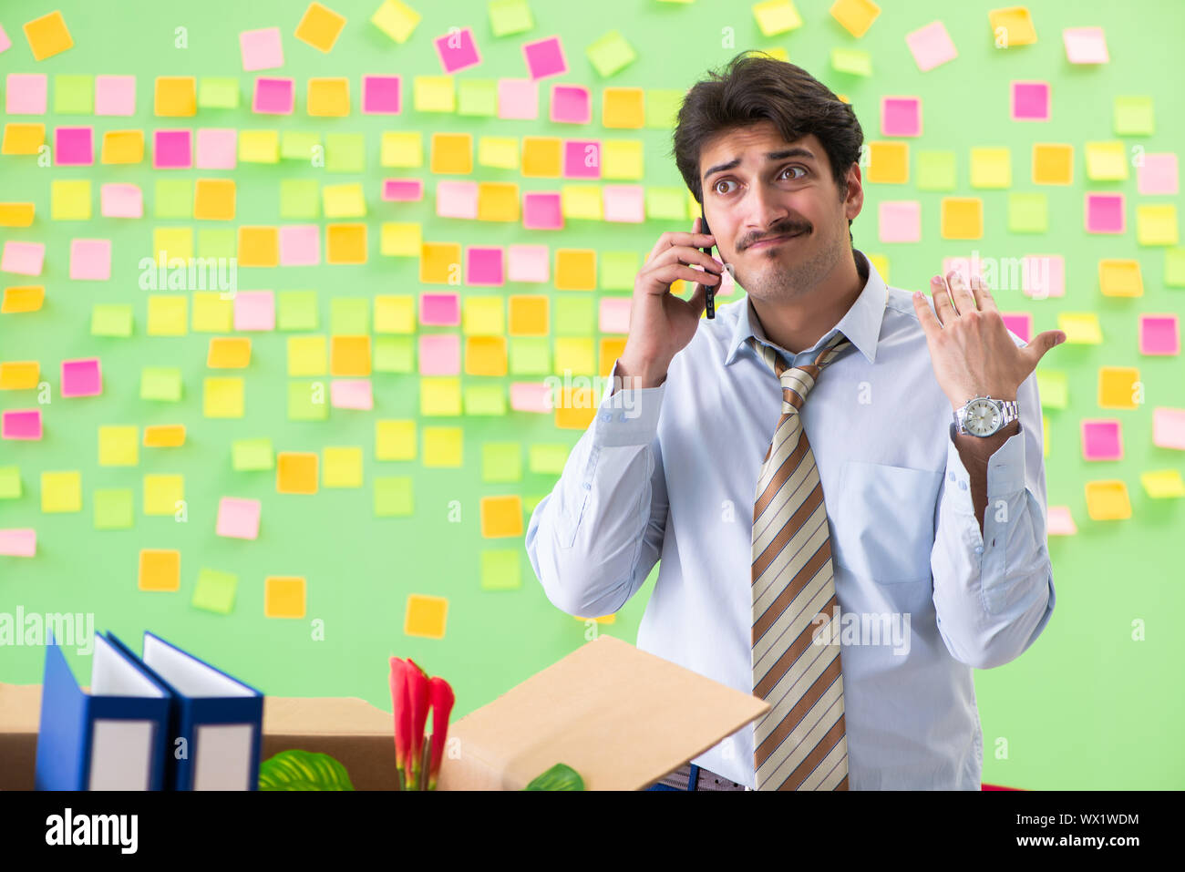 Man collecting his stuff after redundancy in the office with man Stock ...