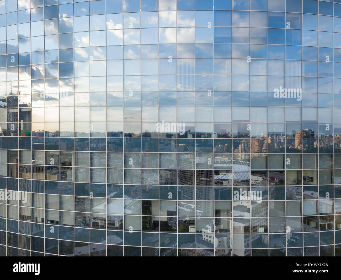 Cityscape reflection on a glass facade of modern office building in ...