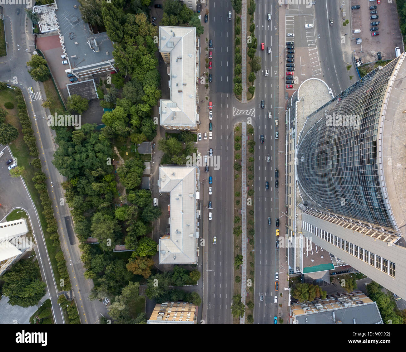 Top view of a modern business center building with a high-speed highway ...