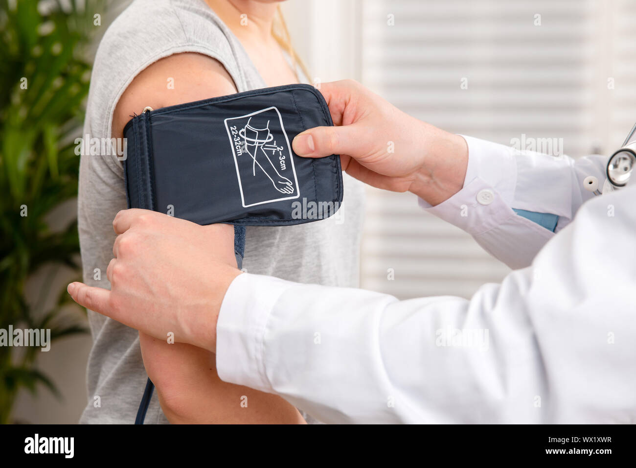 Doctor Checking Blood Pressure Of Patient In Hospital Stock Photo - Alamy