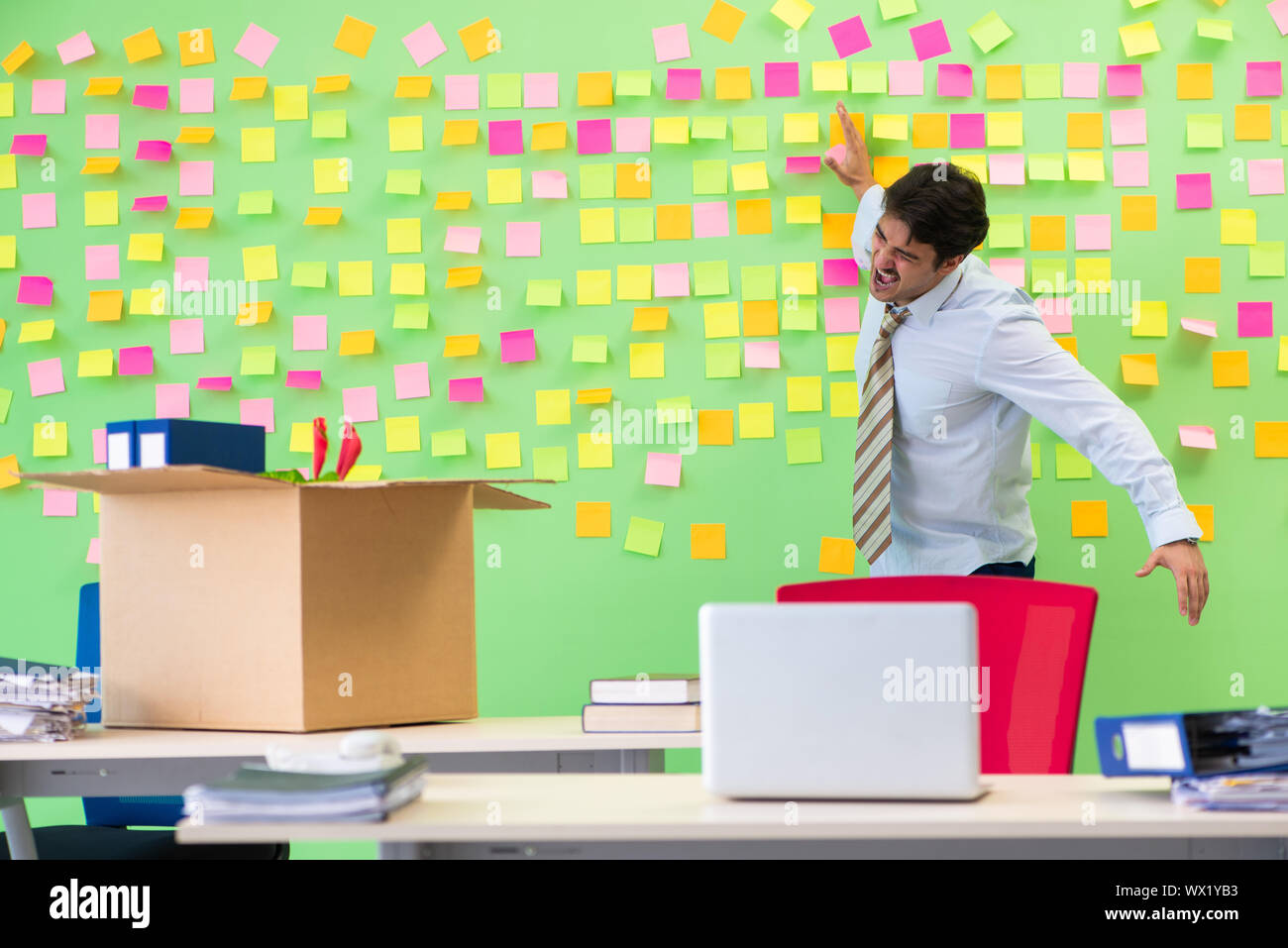 Man collecting his stuff after redundancy in the office with man Stock ...