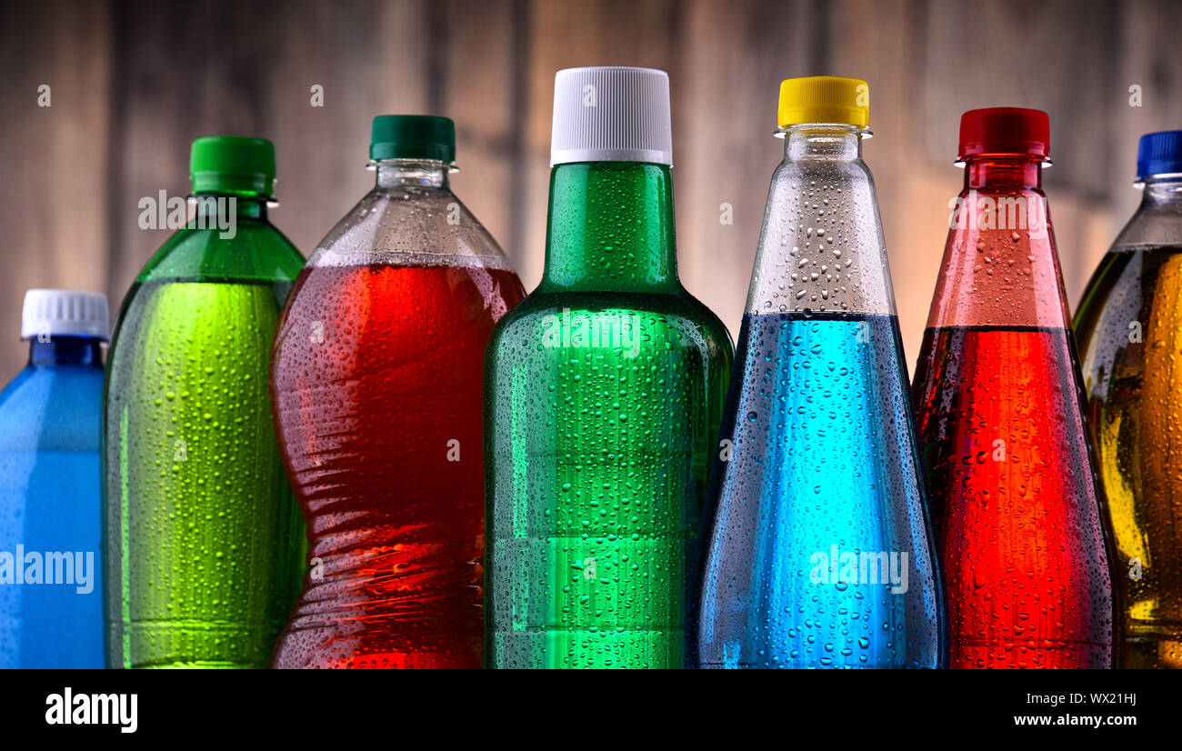 Plastic bottles of assorted carbonated soft drinks in variety of colors ...