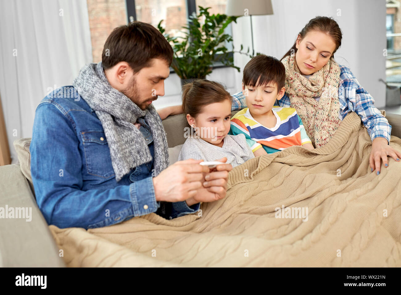 family with ill children having fever at home Stock Photo - Alamy