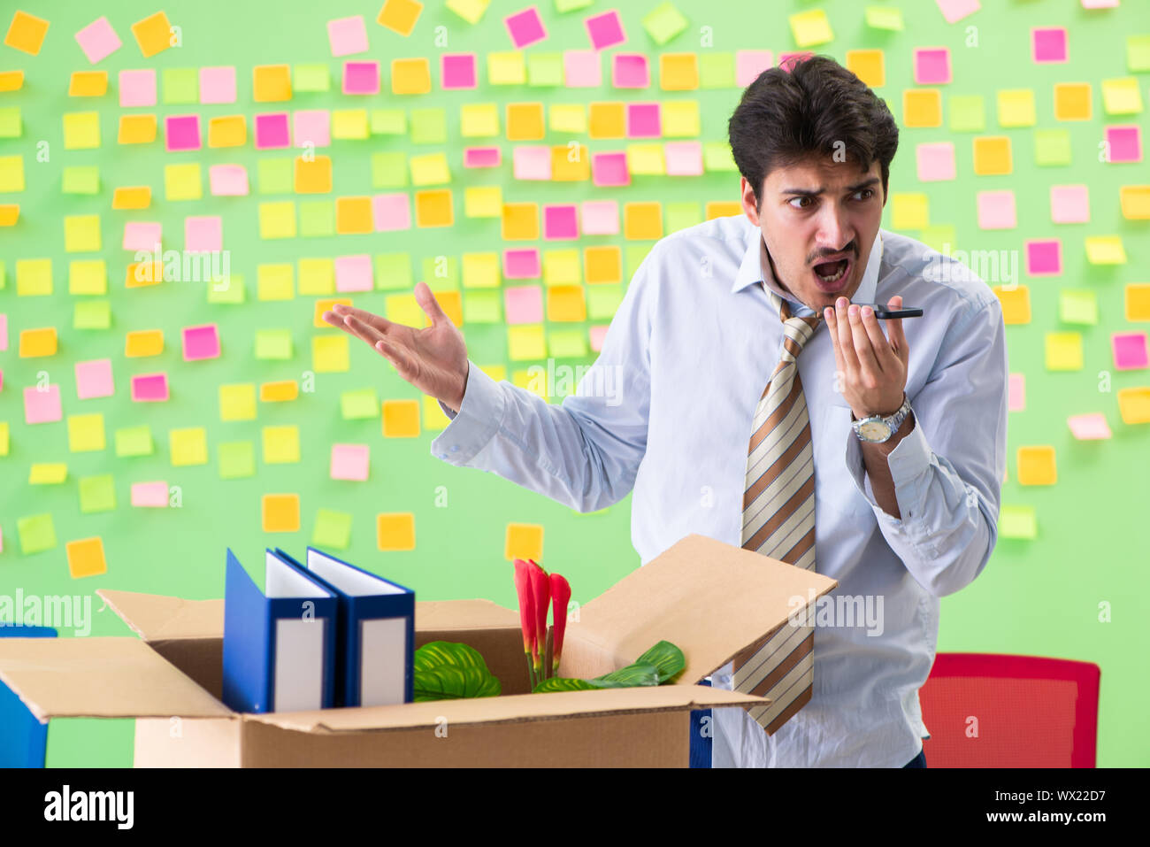 Man collecting his stuff after redundancy in the office with man Stock ...