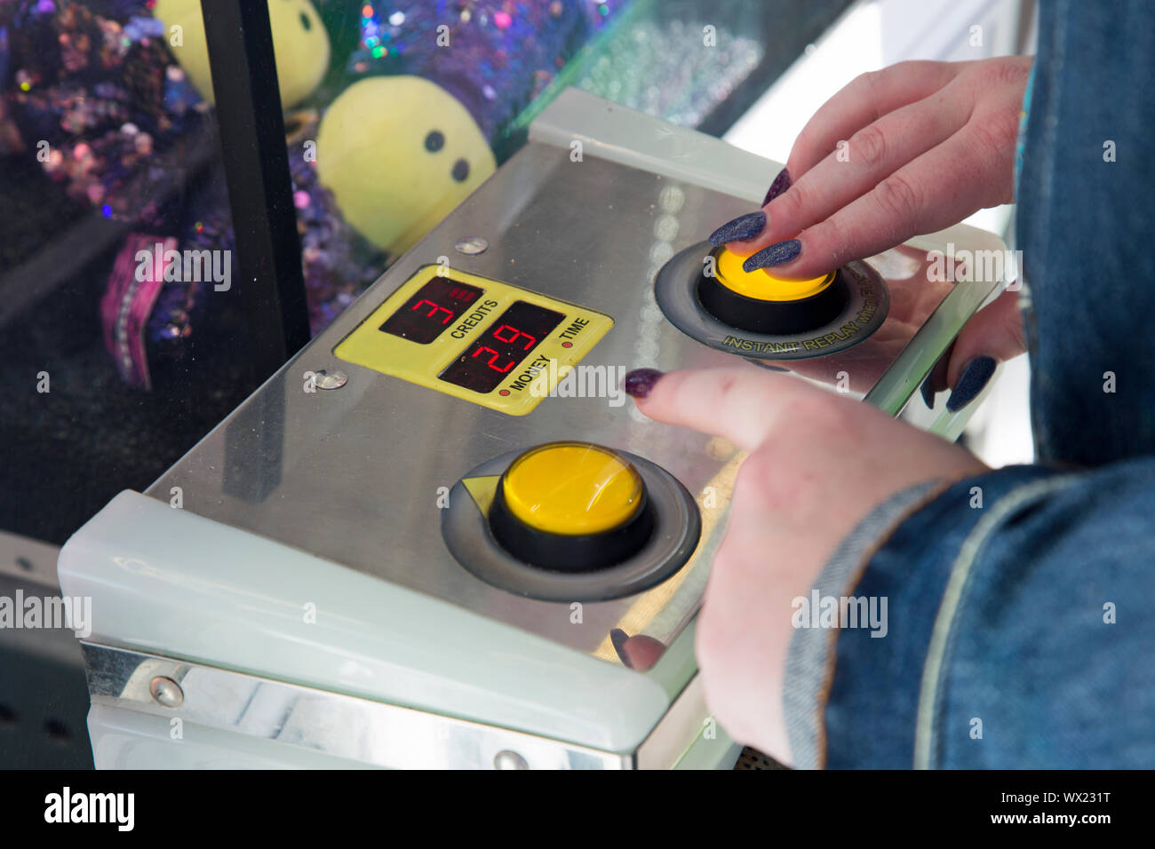 Female fingers on a game machine buttons Stock Photo - Alamy