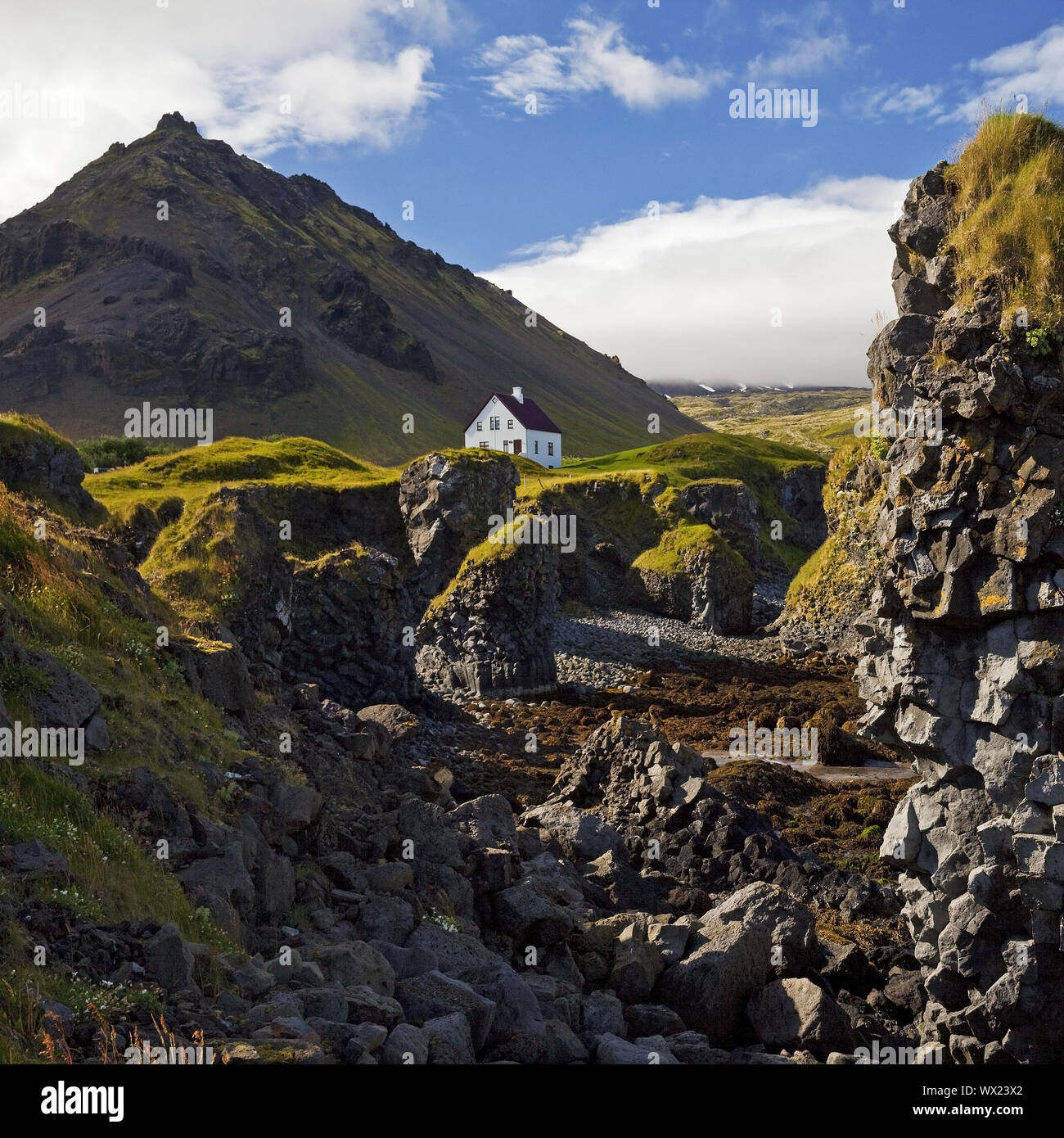 House on the basalt coast off Stapafell mountain, Arnarstapi ...