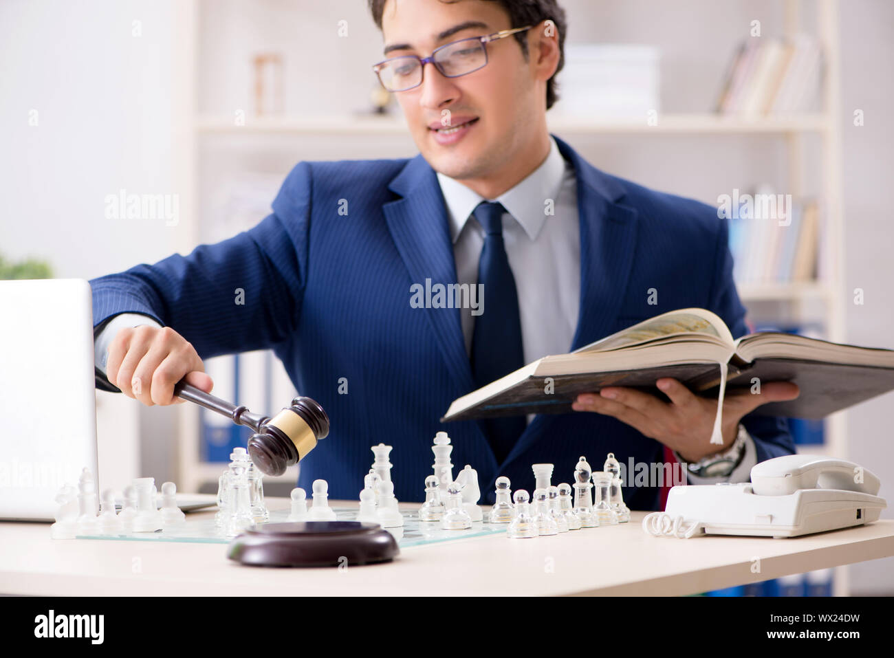 Young lawyer playing chess to train his court strategy and tacti Stock ...